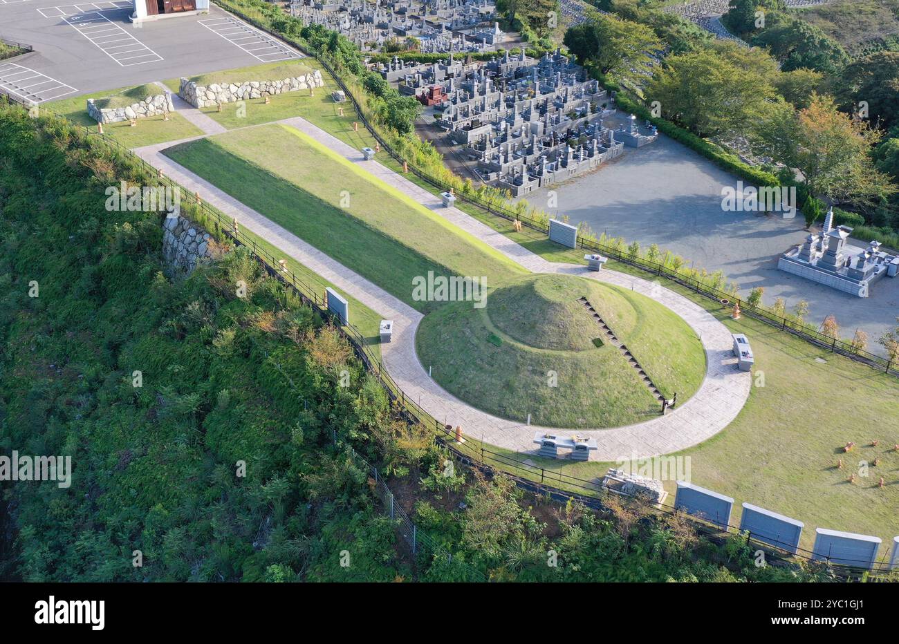 A photo shows a tomb modeled after keyhole-shaped tomb mound on a hill ...