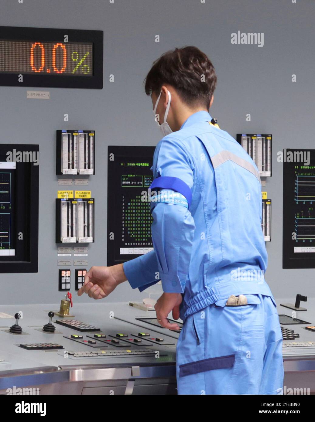 Operator starts the reactor at the central control room of the Onagawa ...