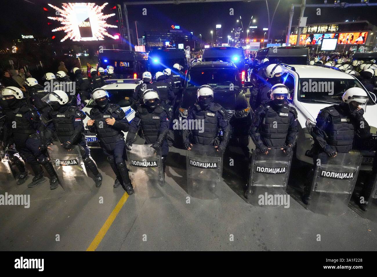 Serbian police officers block a bridge as students and citizens march ...