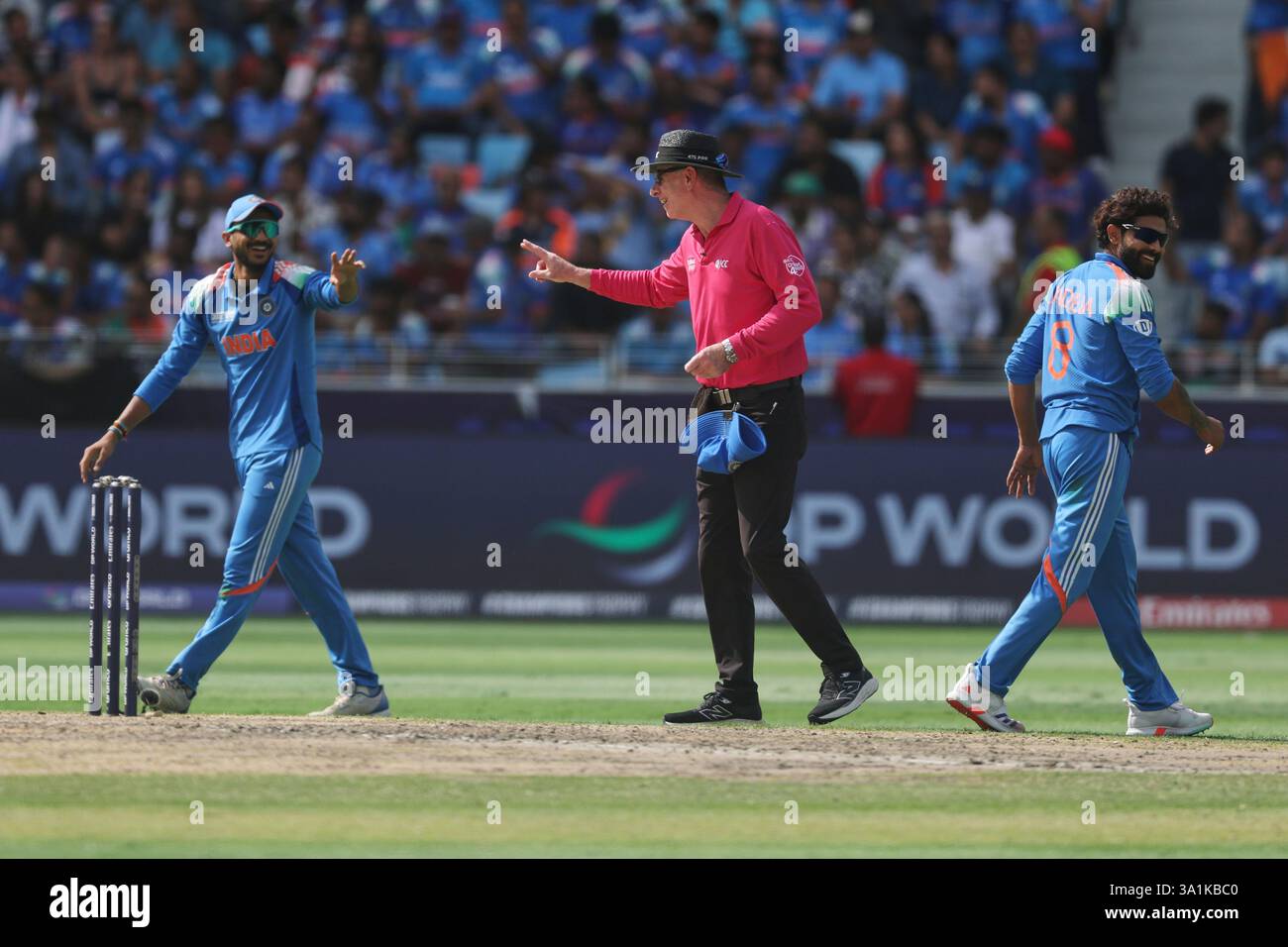 India's Ravindra Jadeja, right, smiles as the umpire Paul Reiffel ...