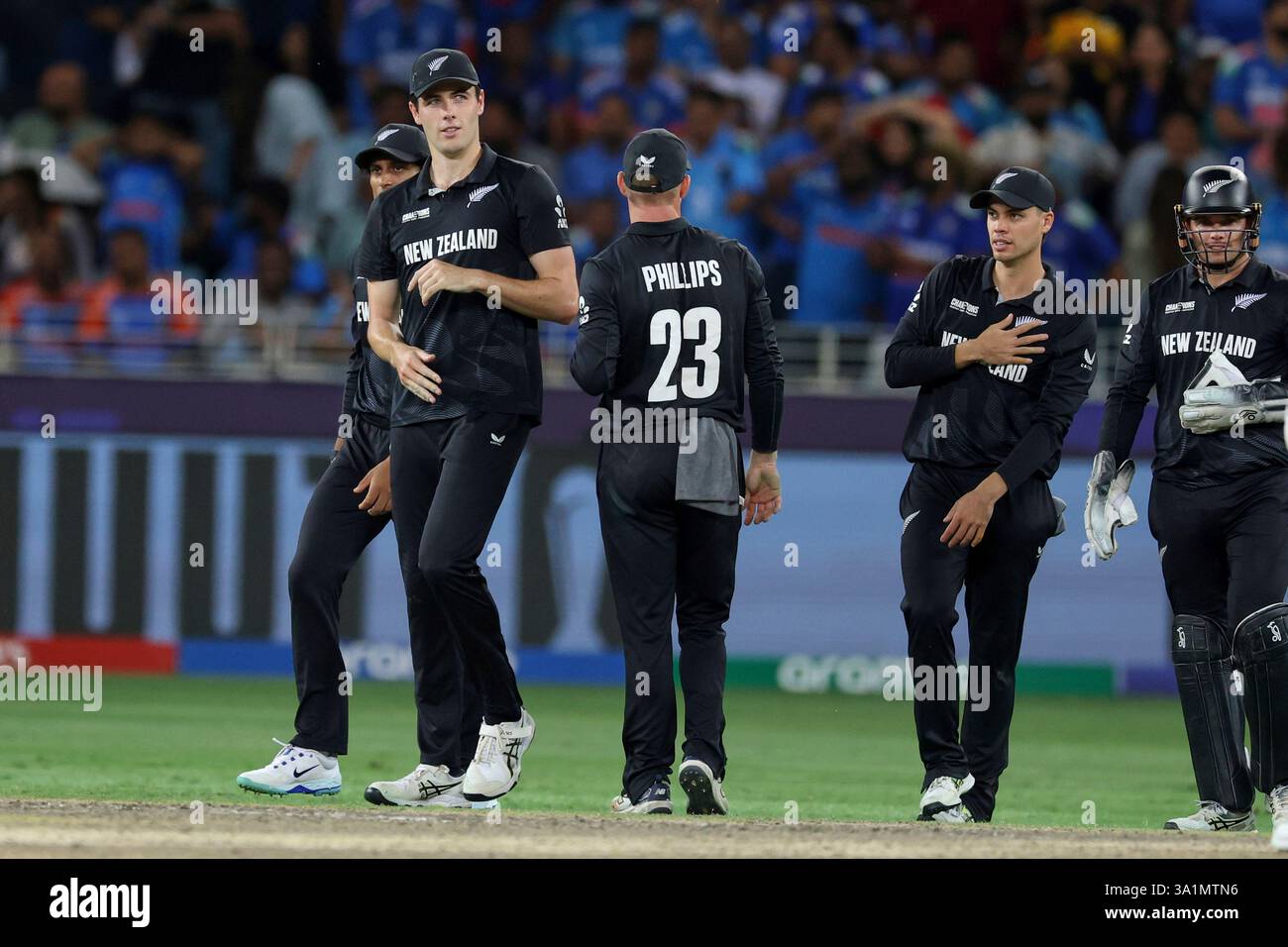 New Zealand's players celebrate the dismissal of India's Axar Patel ...