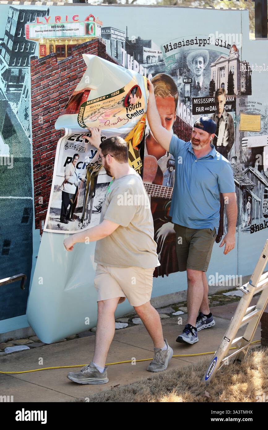 Mark Holland and Anthony Culver, with Fast Wrapz of Tupelo, carry a ...