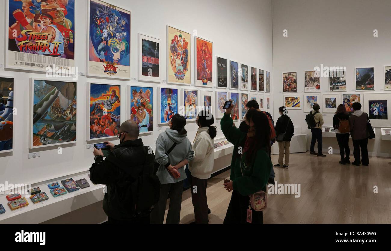 Visitors gaze the poster's main art of "Capcom Creation –moving hearts ...