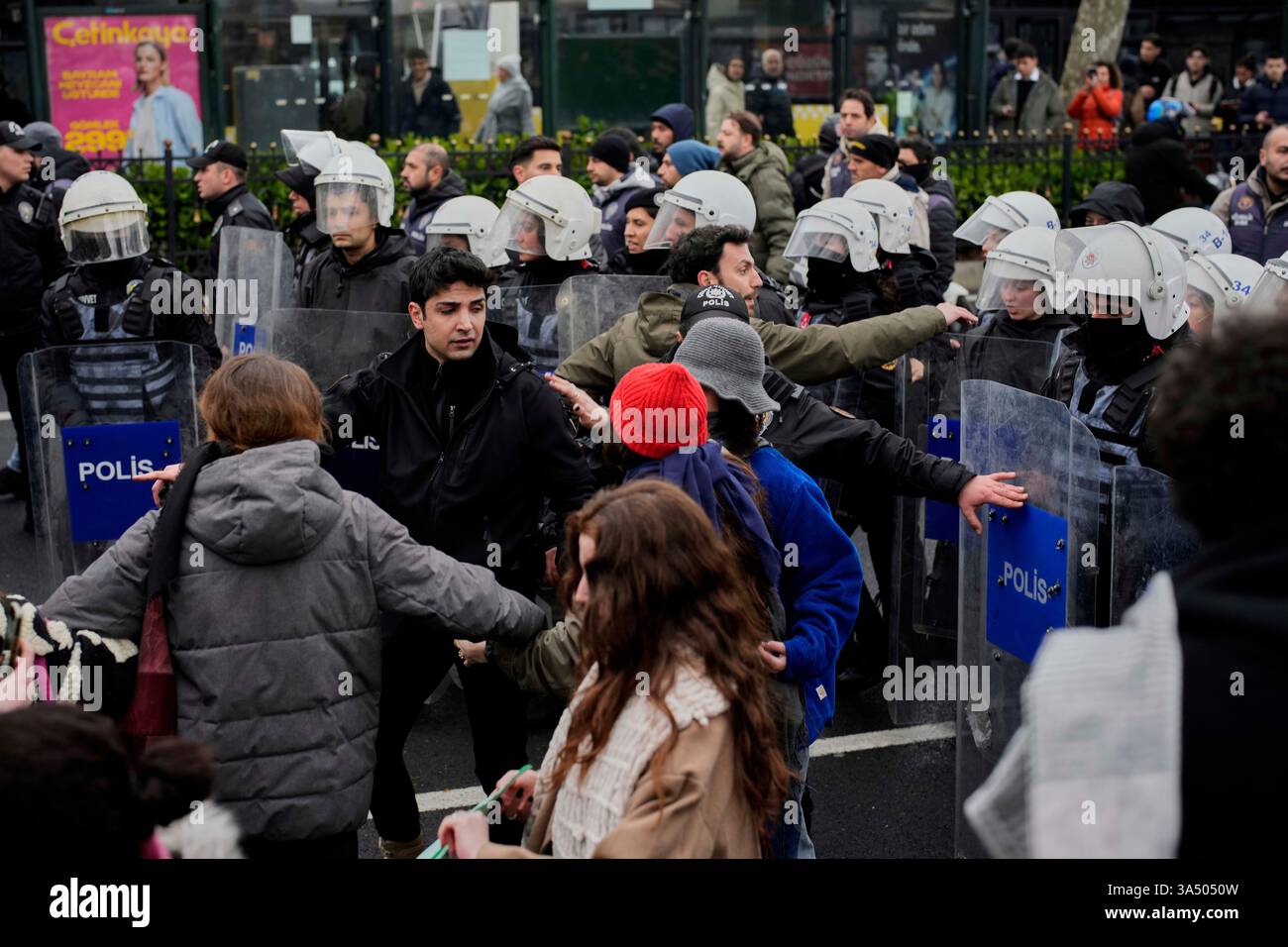 Anti riots police officers block a street as university students march ...