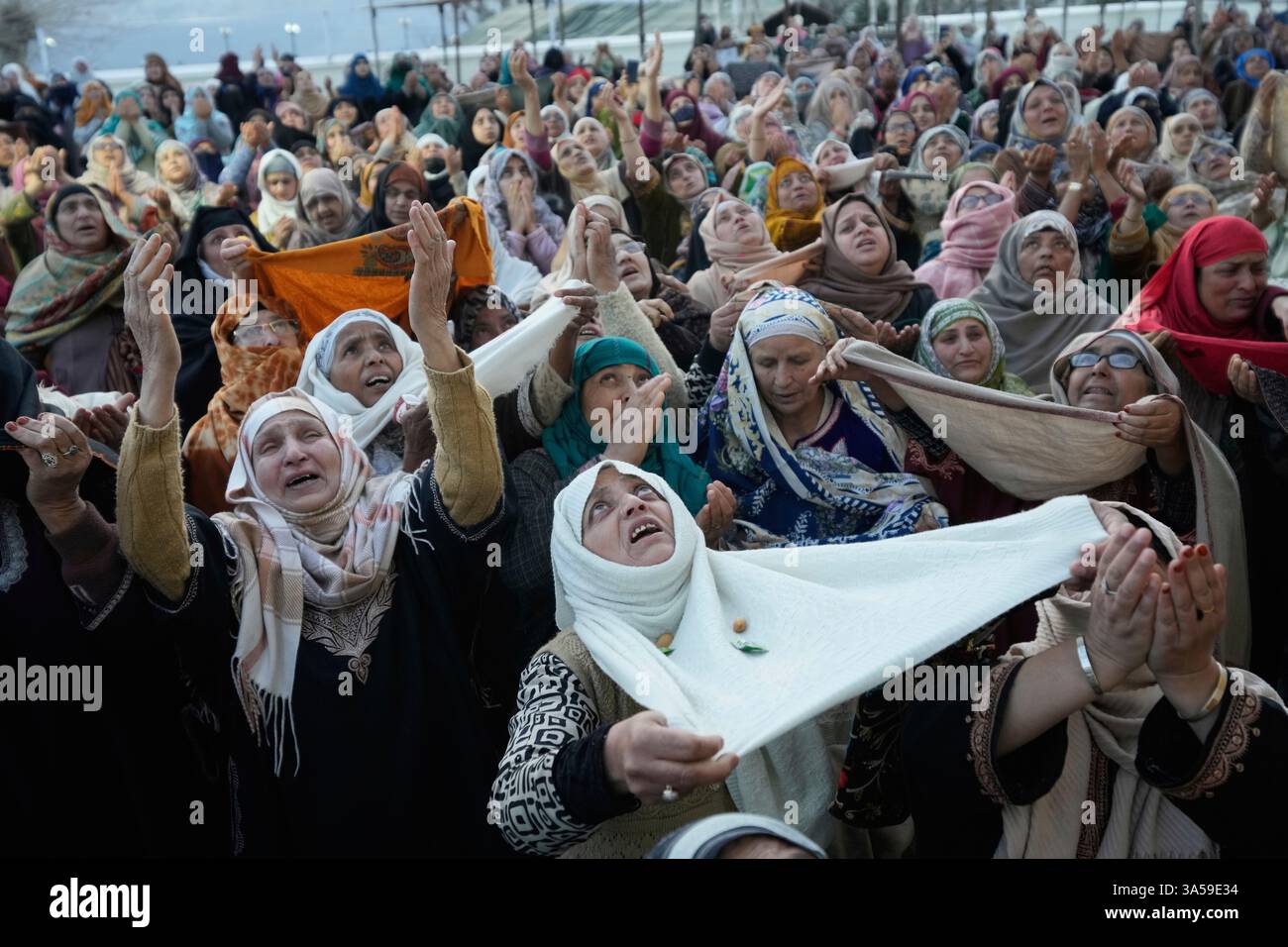 Muslim devotees pray as the head priest displays a holy relic believed ...