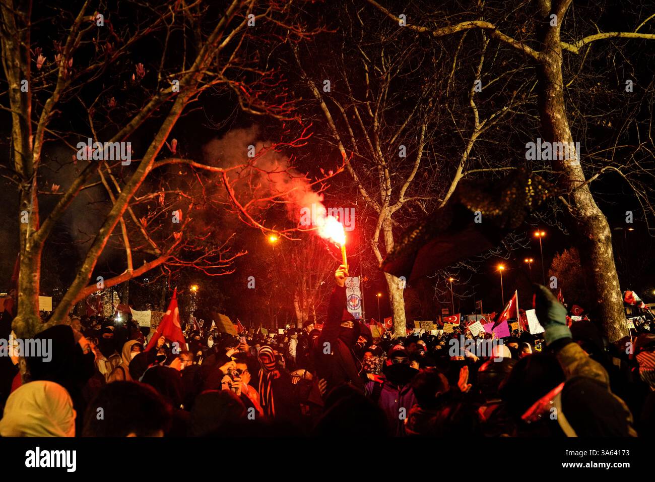 People shout slogans next to anti riot police officers during a protest ...