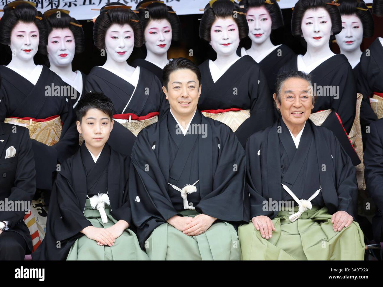 Kabuki actor Onoue Kikunosuke (front row center), his son Onoe Ushinosuke (front row left) and ...