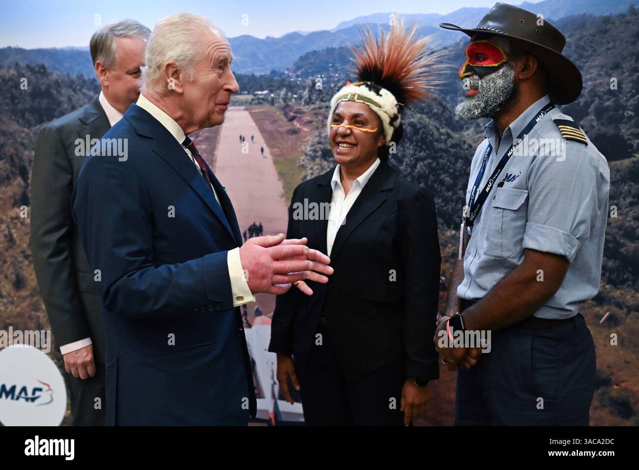 Britain's King Charles III with pilot Joseph Tua and Serah Michael MAF ...