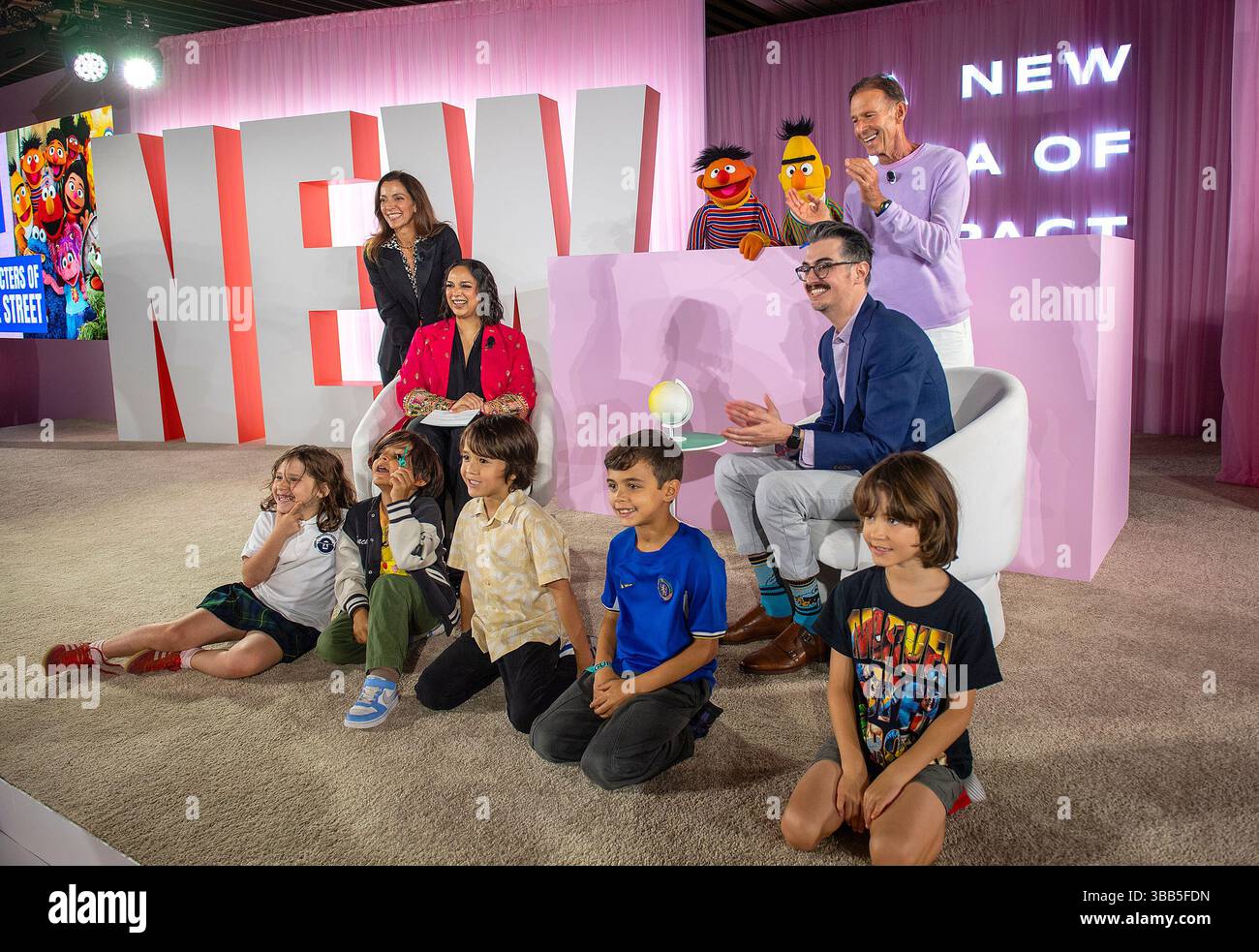 Children pose for photos with Sesame Street's Bert and Ernie and others ...