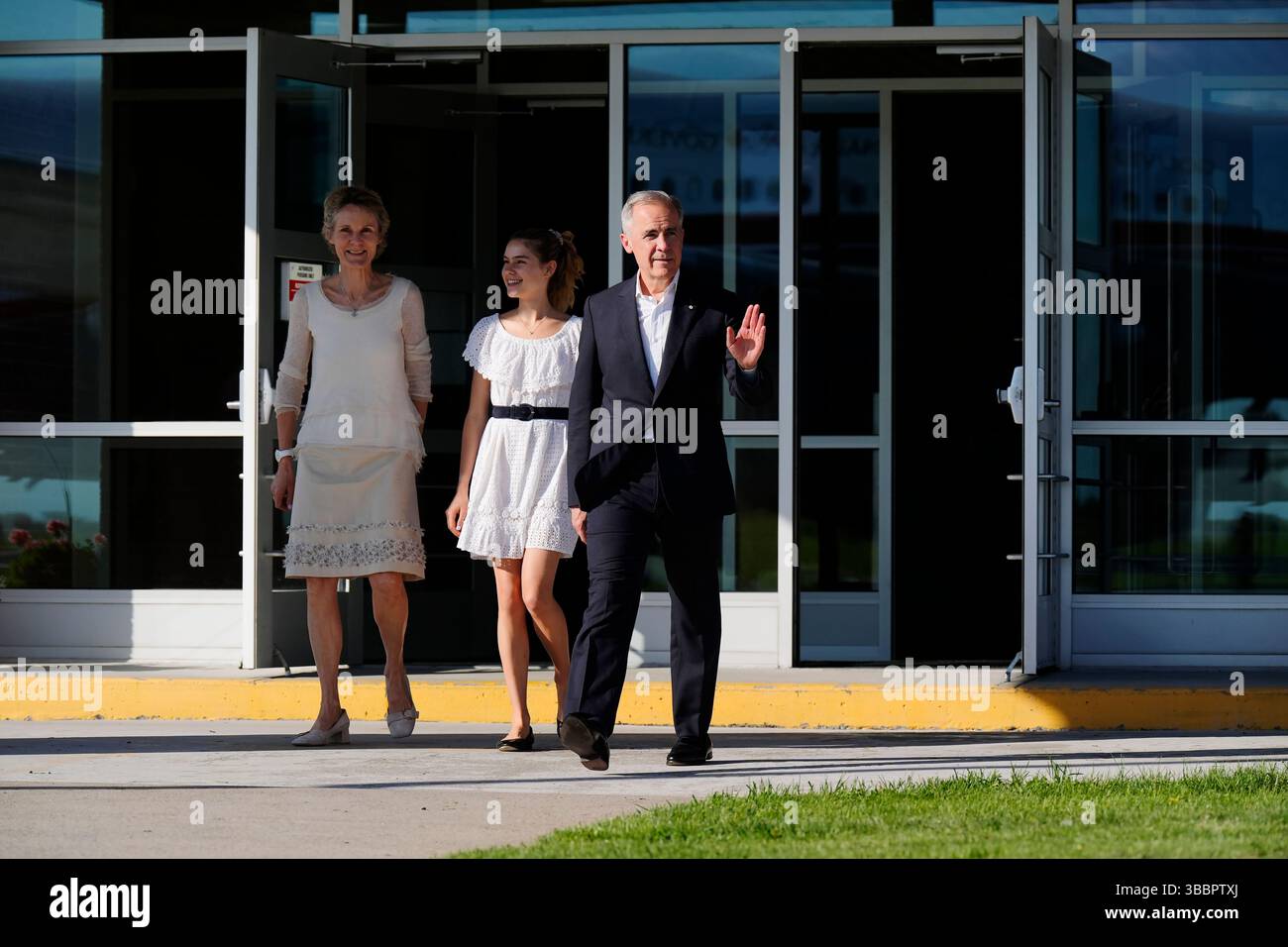 Prime Minister Mark Carney boards a government plane with his wife ...
