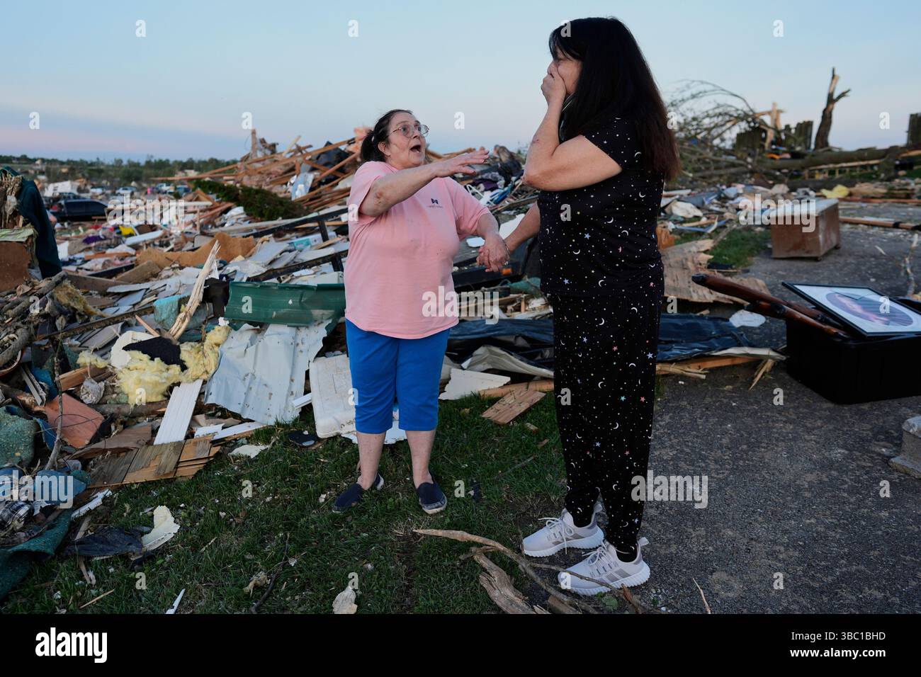 Bea Johnson, left, reaches for her sister Kristie Sexton, right, as she ...