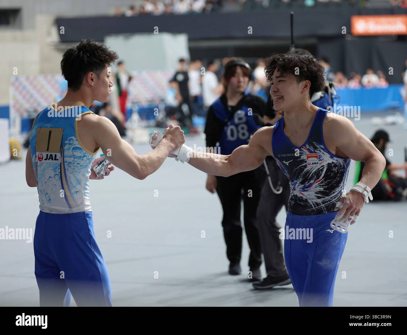Shinnosuke Oka (R) and Daiki Hashimoto congratulate each other on their good performance after ...