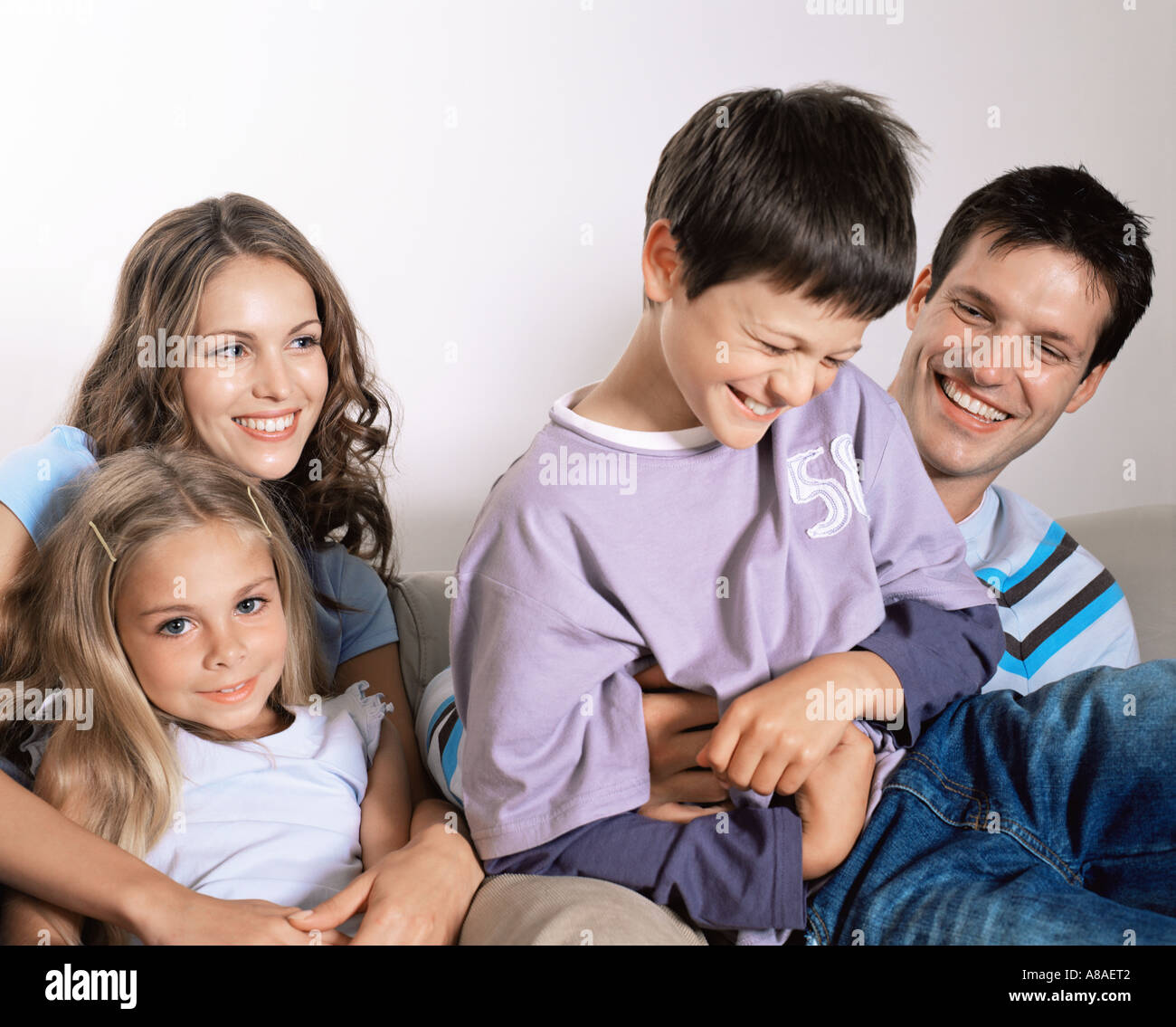 Couple sitting sofa female tickling male Banque de photographies et d ...