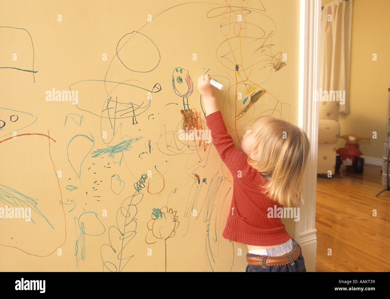 Petite fille écrit sur le mur de sa maison Photo Stock - Alamy
