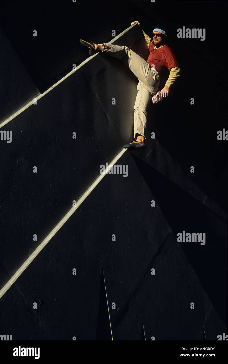 Un jeune homme libre escalade un signe canmore Banque de photographies ...