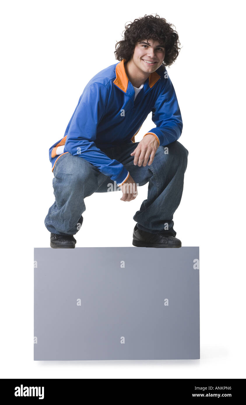 Teen boy crouching on Banque de photographies et d’images à haute ...