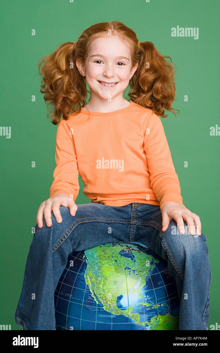 Girl sitting on inflatable globe Photo Stock - Alamy