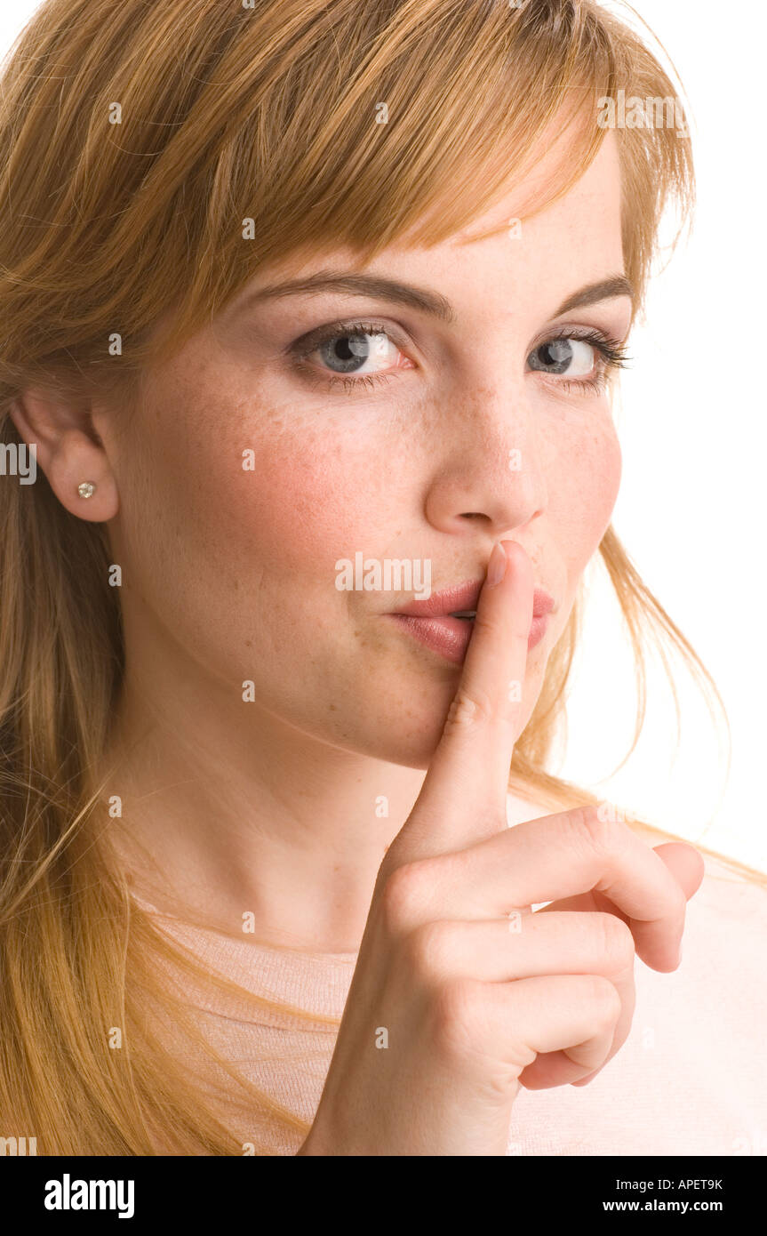 Young blond woman shushing Banque de photographies et d’images à haute ...