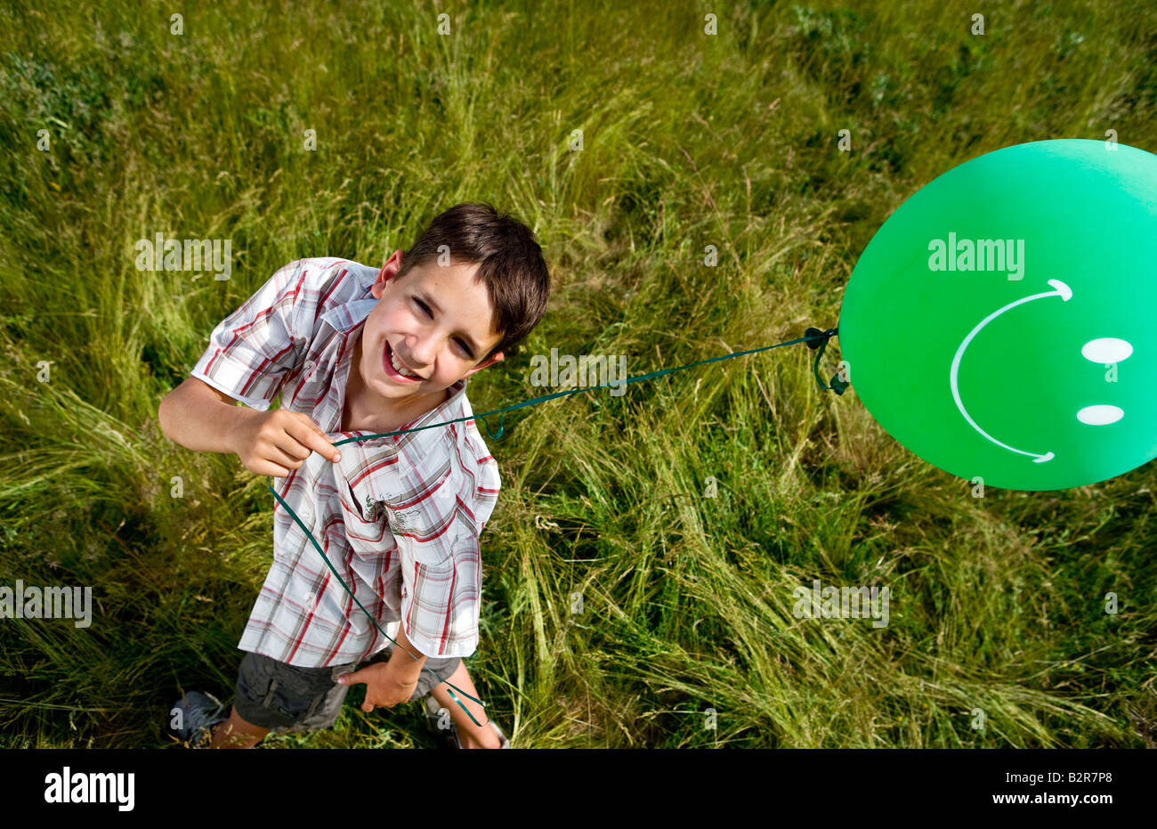 Boy holding smiley face balloon Banque de photographies et d’images à ...