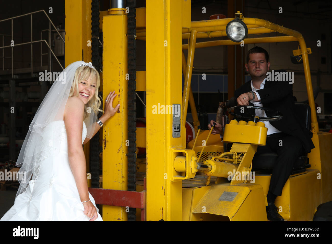 Une bride sur les fourches d'un chariot élévateur conduit par son époux ...