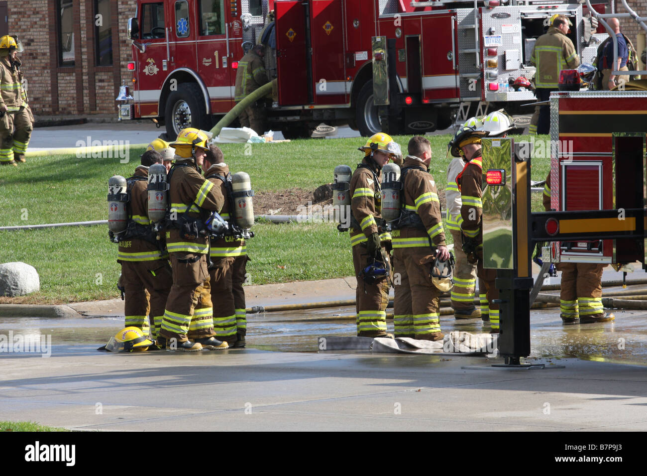 Un grand groupe des pompiers sur les lieux d'un incendie industriel ...