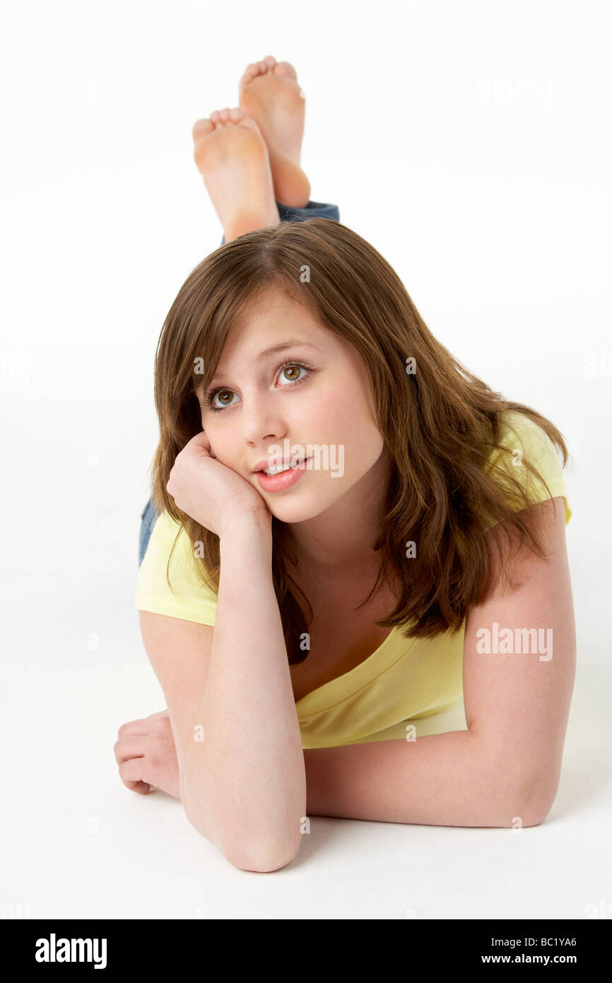Young Girl Lying On Stomach In Studio Photo Stock - Alamy