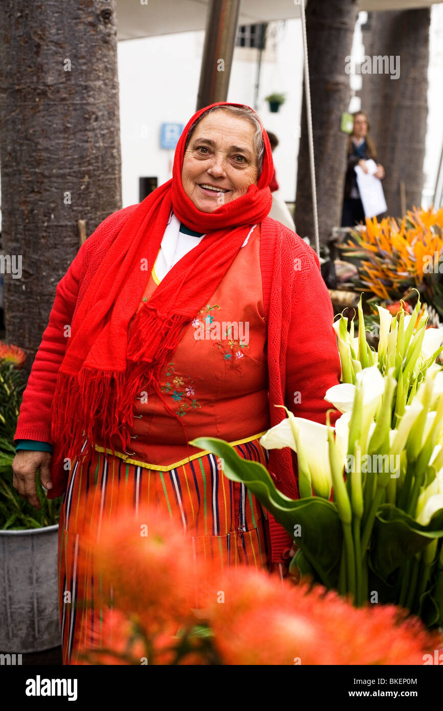 Une marchande de fleurs dans une robe rouge costume traditionnel de ...