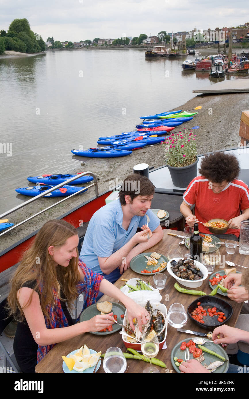 Les amis manger le déjeuner à l'extérieur, sur un bateau amarré sur la ...