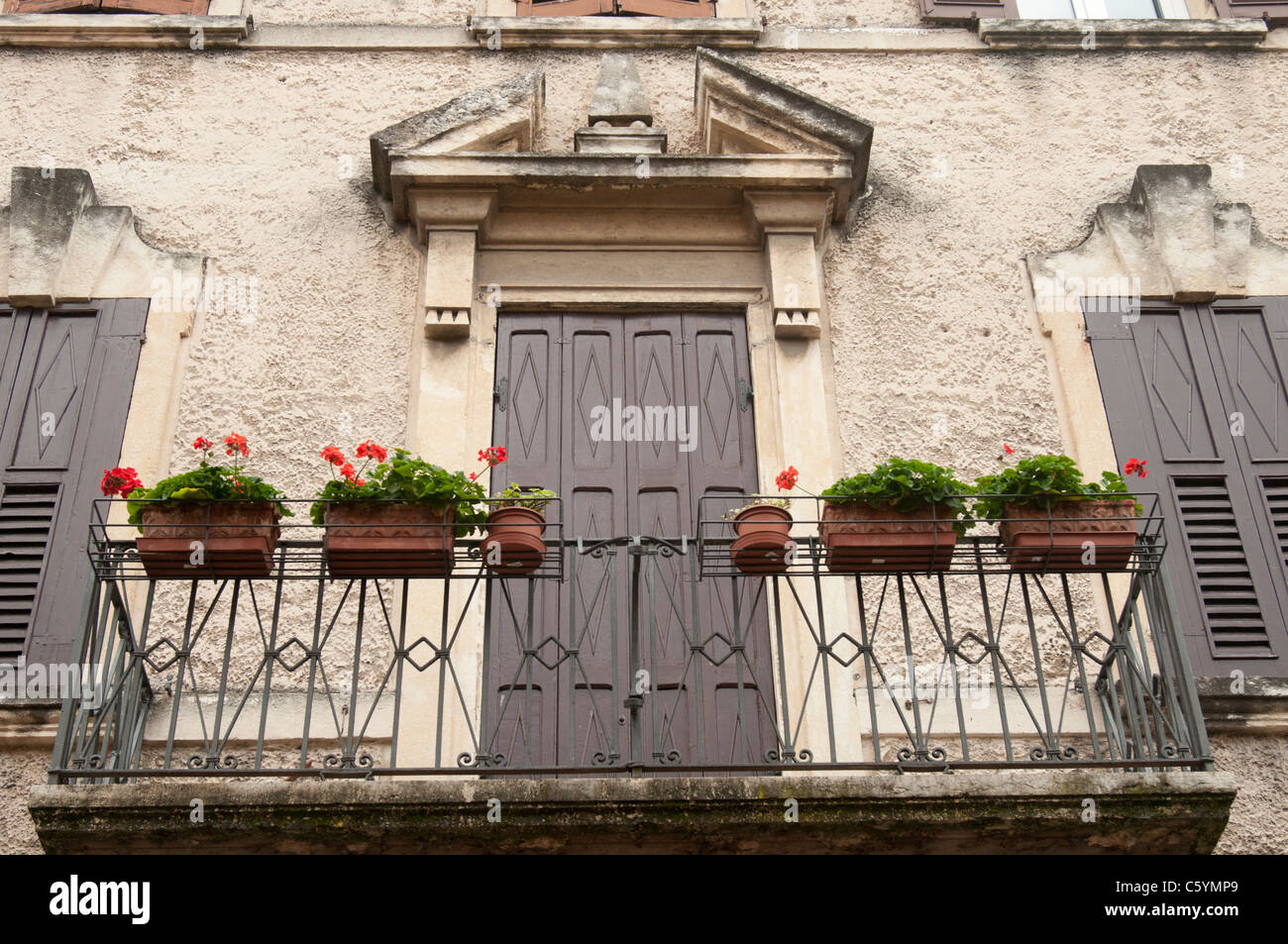 Balcon en fer forgé avec portes et fenêtres à volets, à Vérone, Italie ...