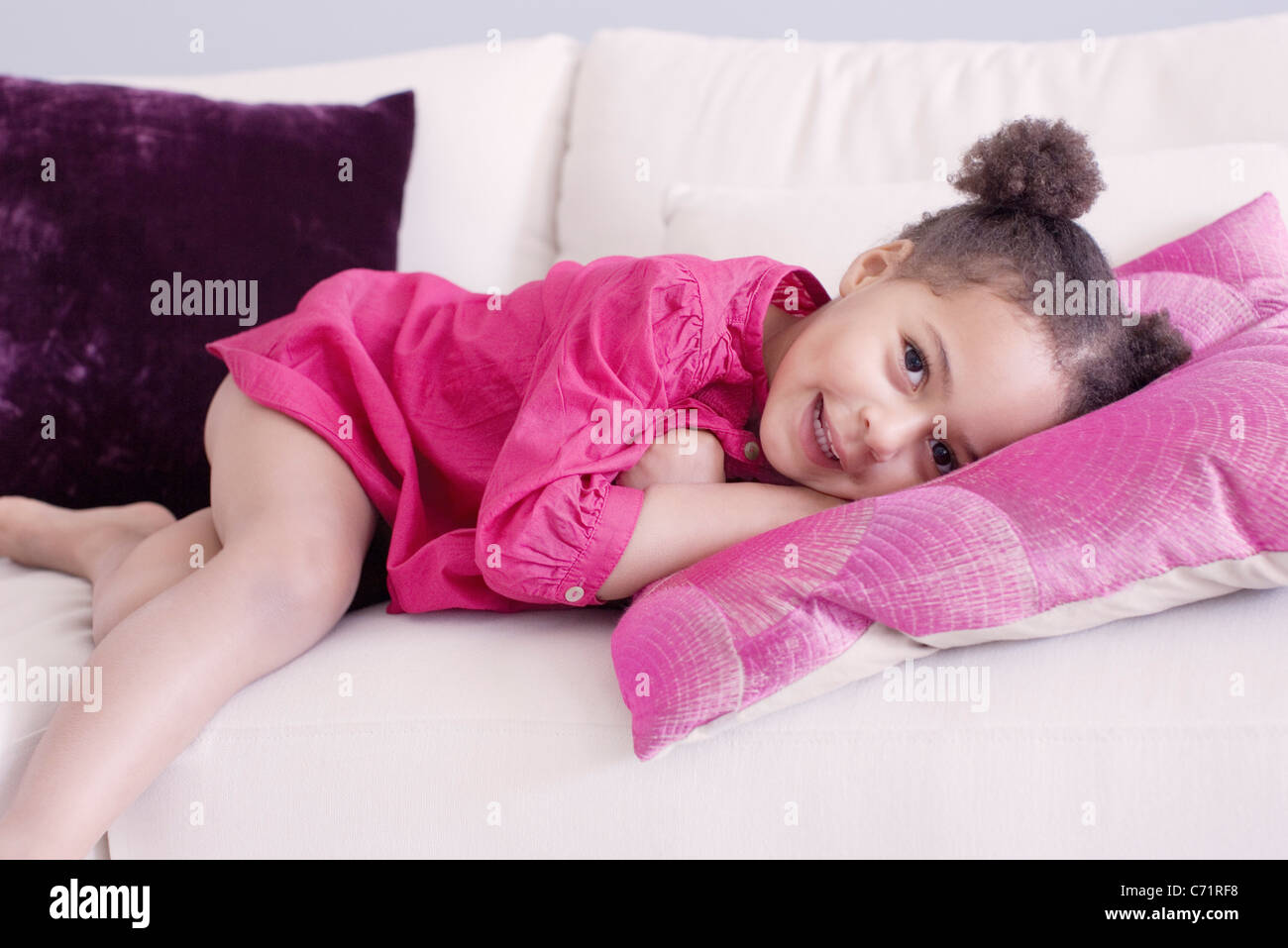 Little girl lying on couch Photo Stock - Alamy