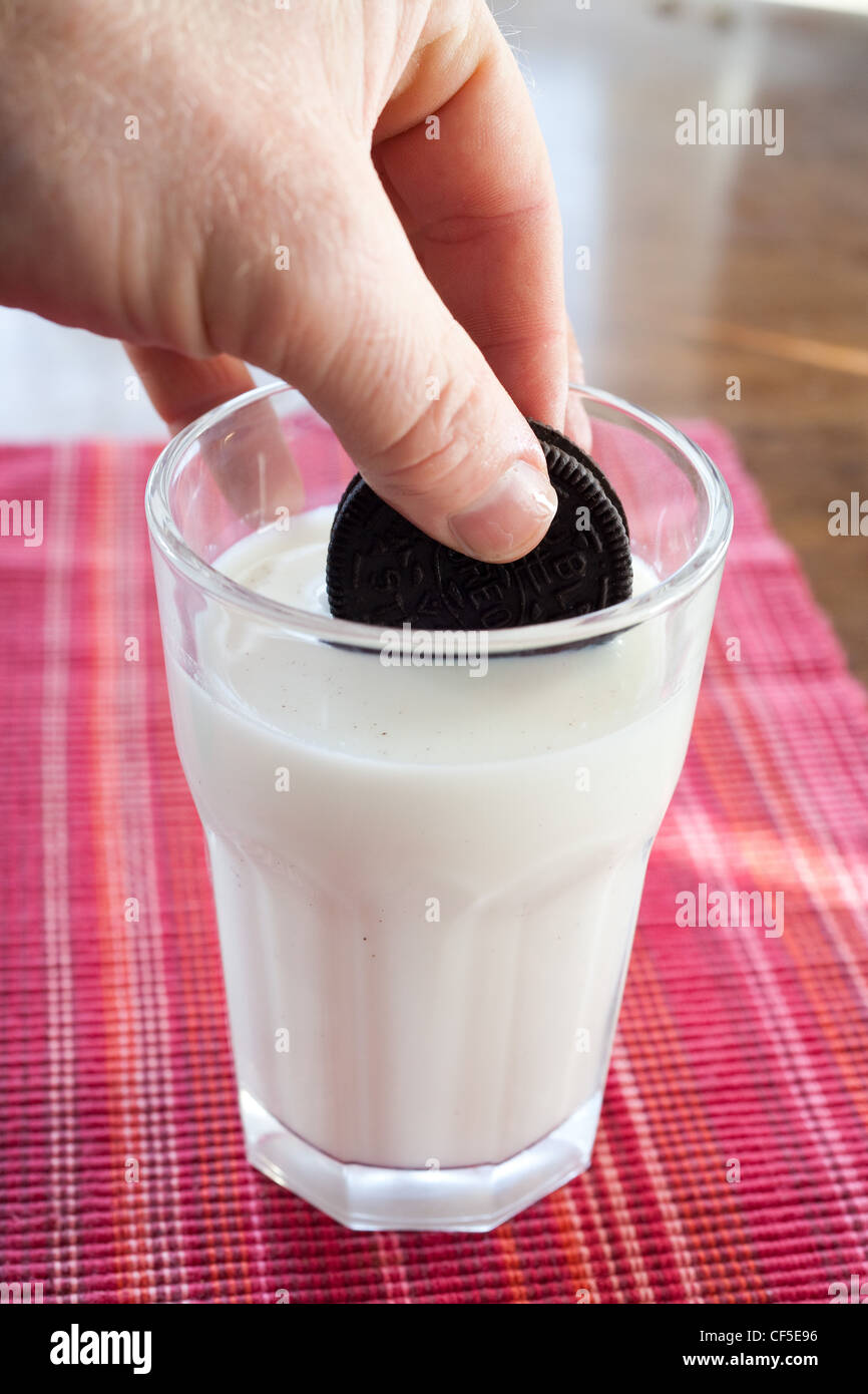 Tremper un biscuit Oreo dans un verre de lait Photo Stock - Alamy