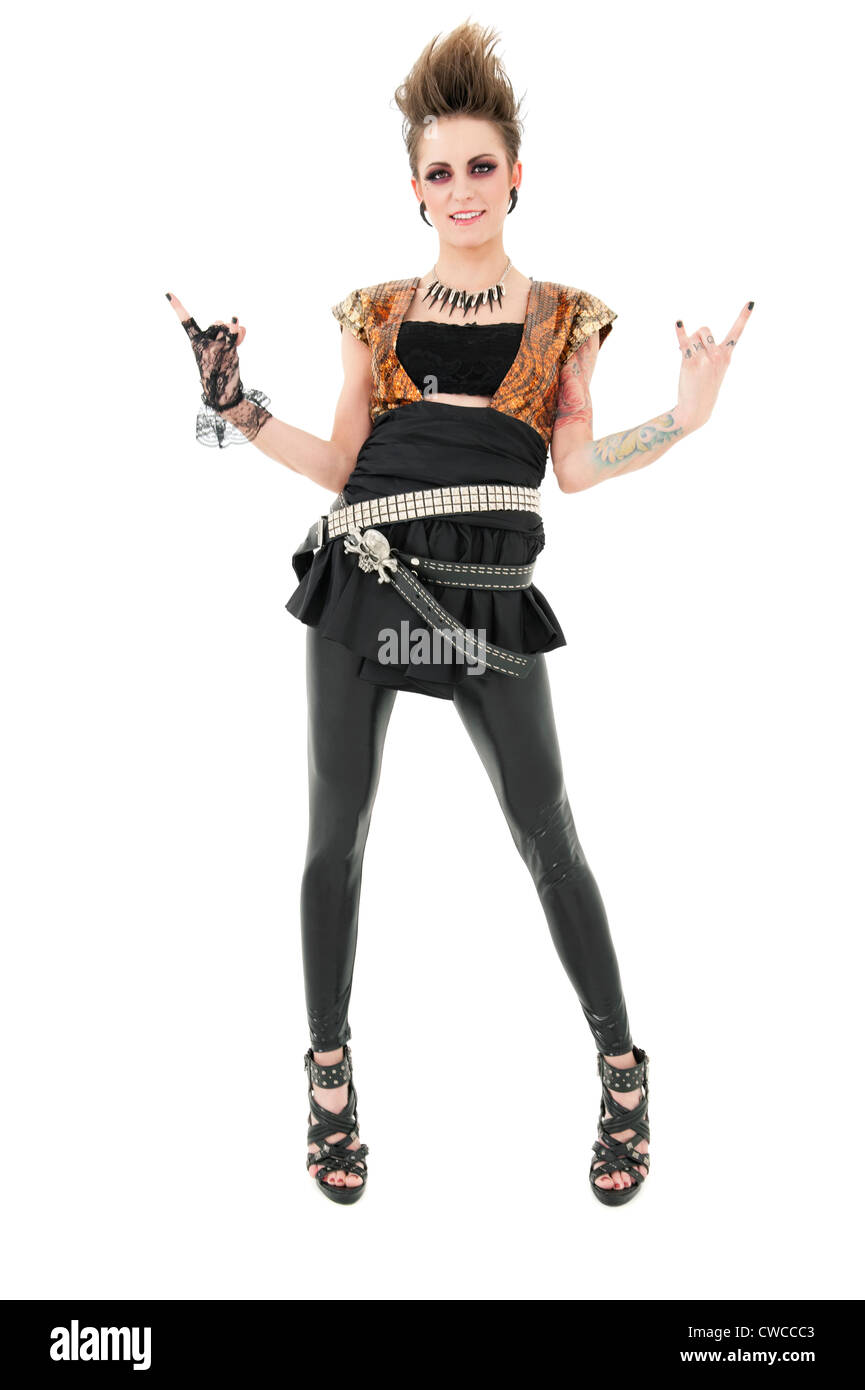 Portrait of woman gesturing punk rock sign over white background Photo ...