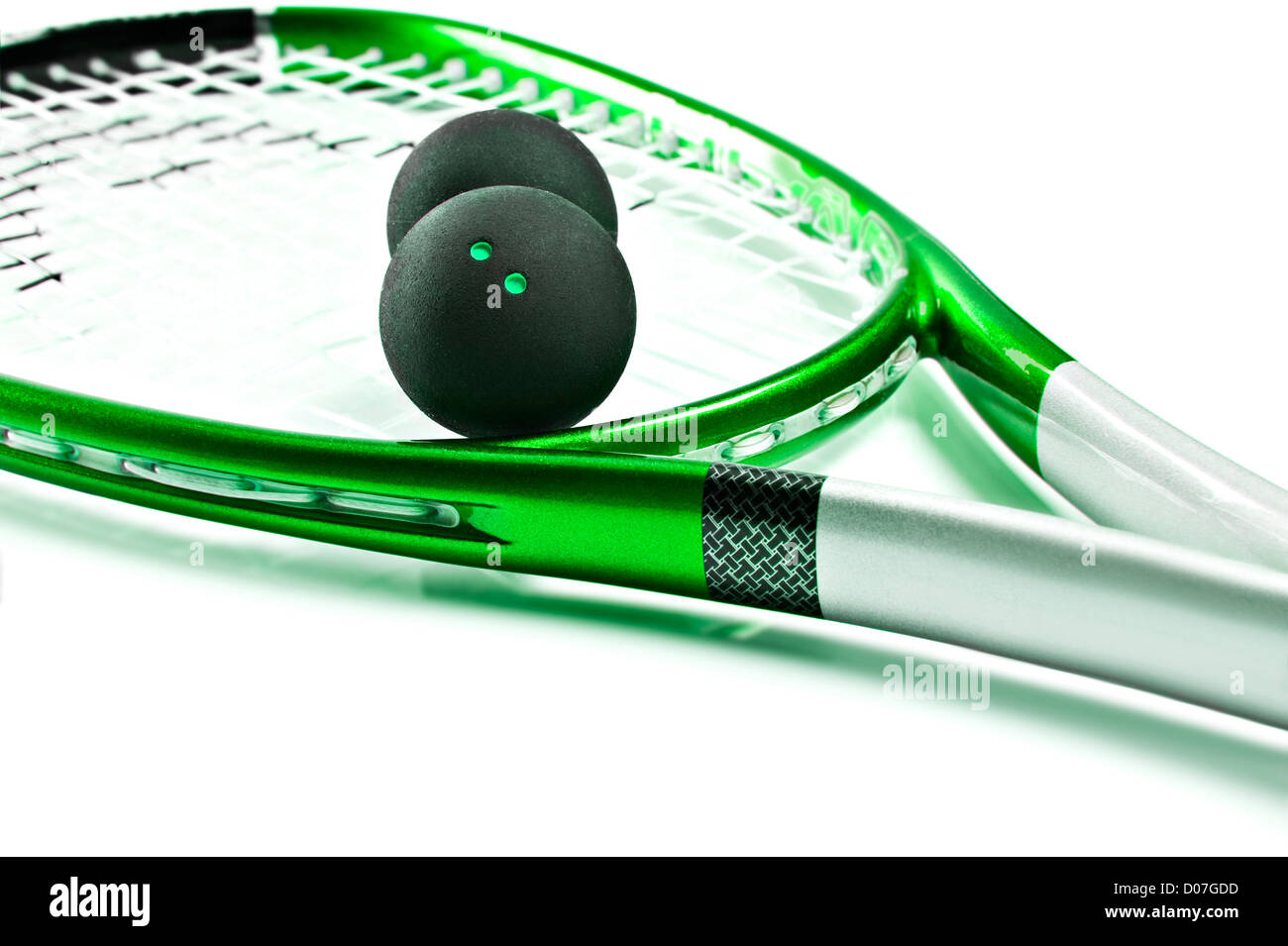 Raquette de Squash avec des boules vertes sur fond blanc avec un espace ...