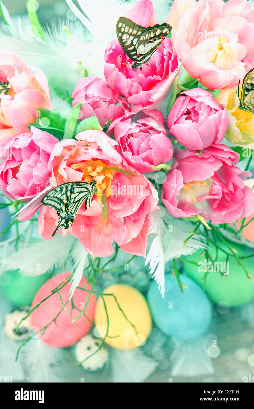 Tulipe rose fleurs, papillons et œufs de Pâques colorés. focus sélectif. les effets de flou de ...