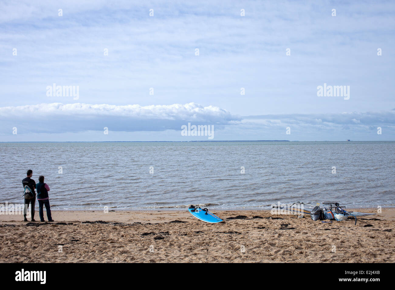 Les véliplanchistes standing on beach, Fouras, Charente-Maritime ...