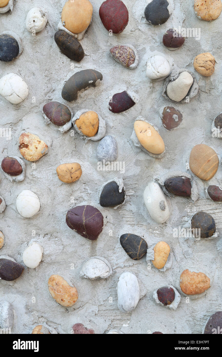 Cailloux dans mur en béton texture background Photo Stock - Alamy
