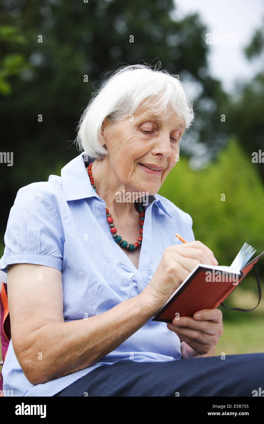 80 ans, femme, et écrit dans son journal Photo Stock - Alamy