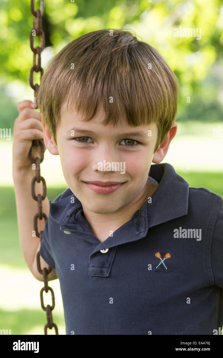 Young boy playing in Backyard Swing, USA Photo Stock - Alamy