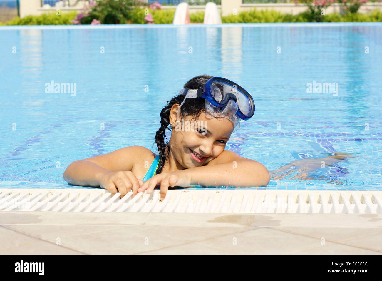 Smiling cute little girl (6-7) having fun in swimming pool Photo Stock ...