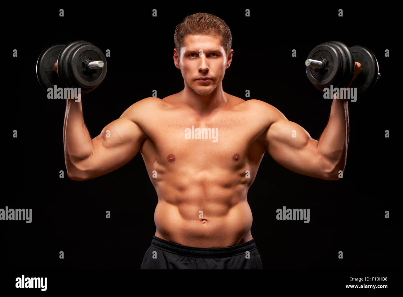 Puissant sérieux sportif musclé torse nu les muscles biceps de pompage ...