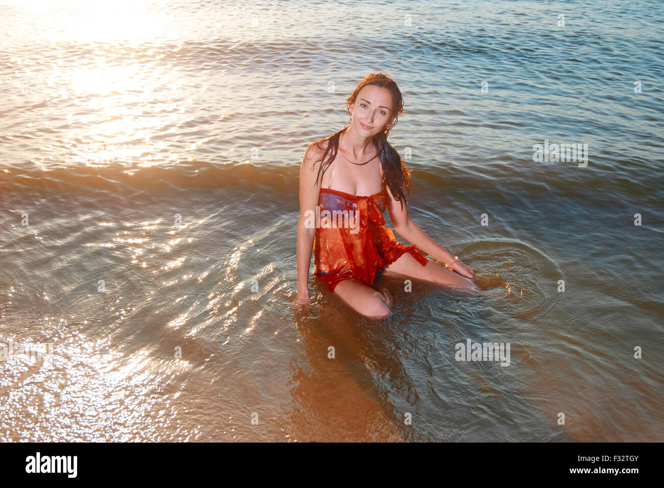 Belle Jeune Fille En Bikini Redhaired Azure Et Tunique Orange Posant