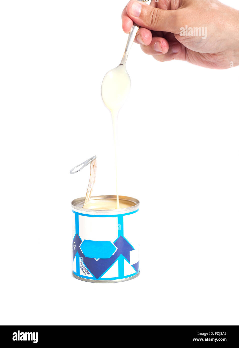 Boite de conserve de lait concentré avec cuillère isolated on white ...