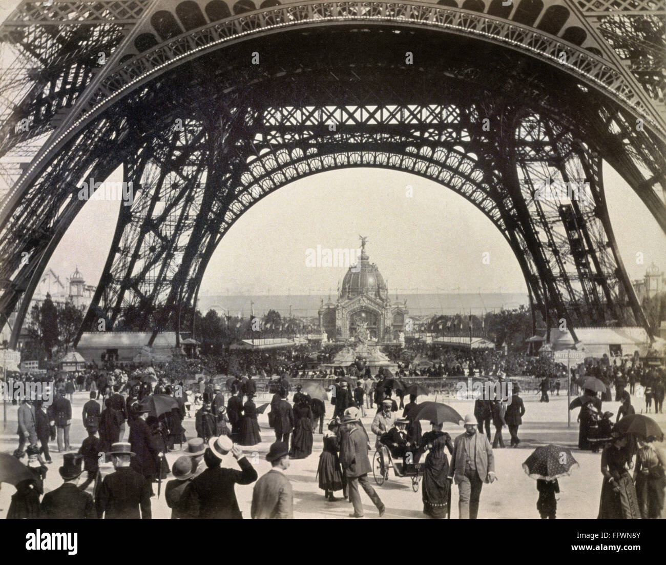 EXPOSITION DE PARIS, 1889. /NCrowds marcher sous la base de la Tour Eiffel à l'Expostion ...