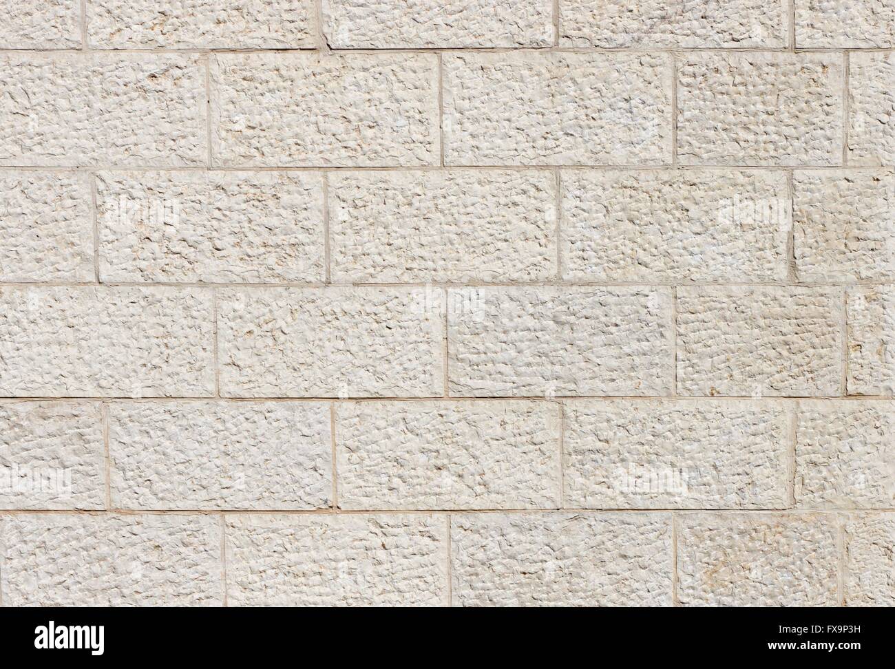 La texture du mur vertical construit de blocs de pierre beige Photo ...