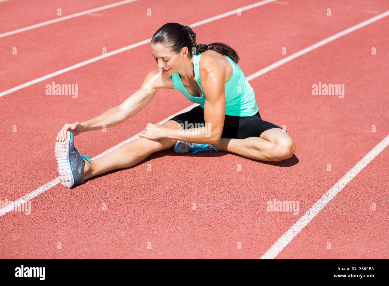 Étirement des ischio-jambiers son athlète féminine Photo Stock - Alamy
