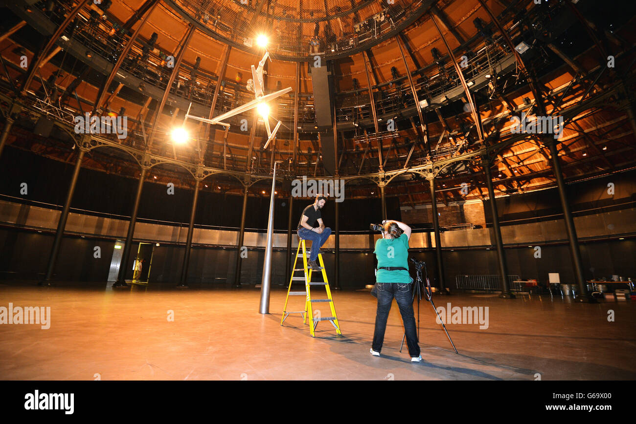 British artist conrad shawcross sits under his artwork titled timepiece ...