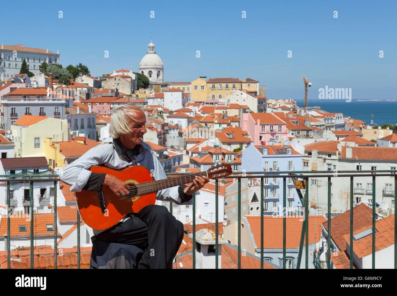 Musicien ambulant qui joue de la guitare dans le soleil chaud de ...
