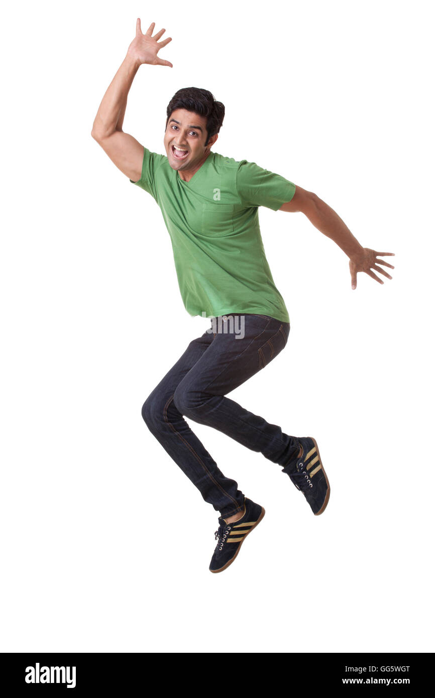 Beau jeune guy jumping over white background Photo Stock - Alamy