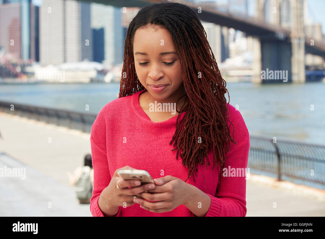 Black woman using cell phone at waterfront Photo Stock - Alamy