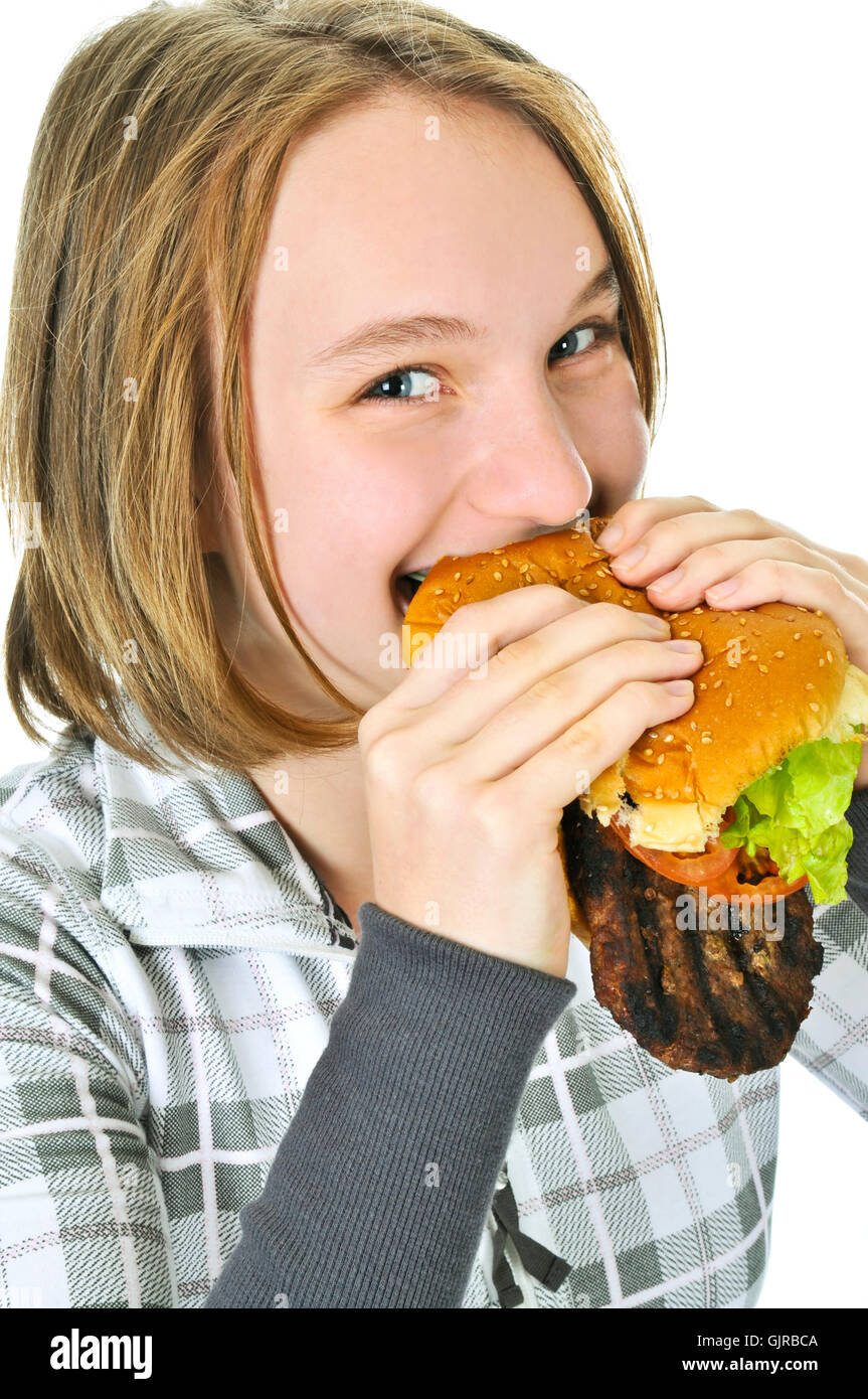Teen biting into burger Banque de photographies et d’images à haute ...